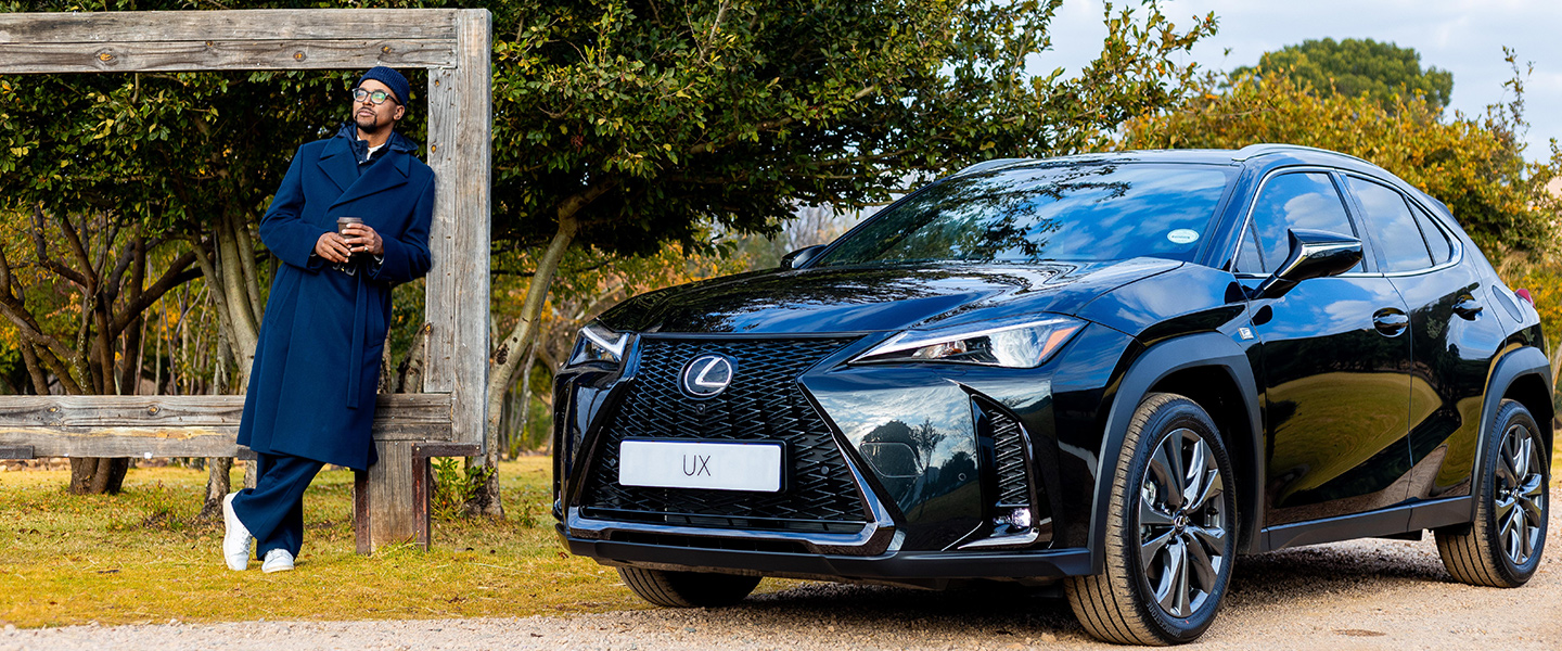 Maps Maponyane next to the Lexus UX F Sport